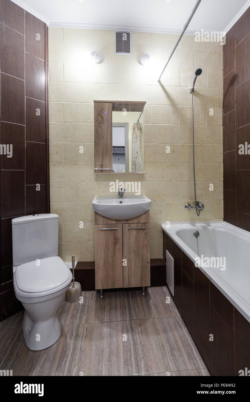 Modern wooden small restroom with little sink Stock Photo - Alamy