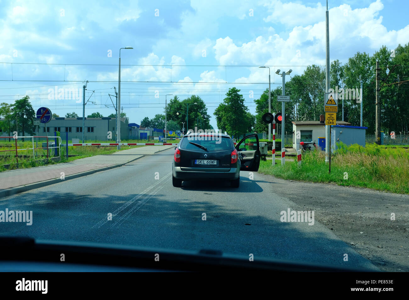 A car waiting at a railway level crossing in Lubliniec, Poland EU Stock ...