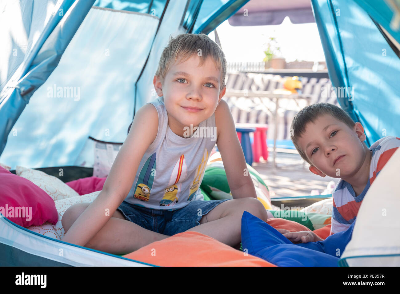 Portrait of cute boy inside tent at backyard Stock Photo - Alamy
