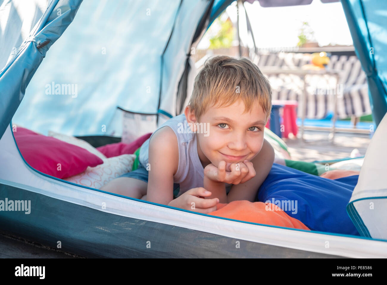 Portrait of cute boy inside tent at backyard Stock Photo - Alamy