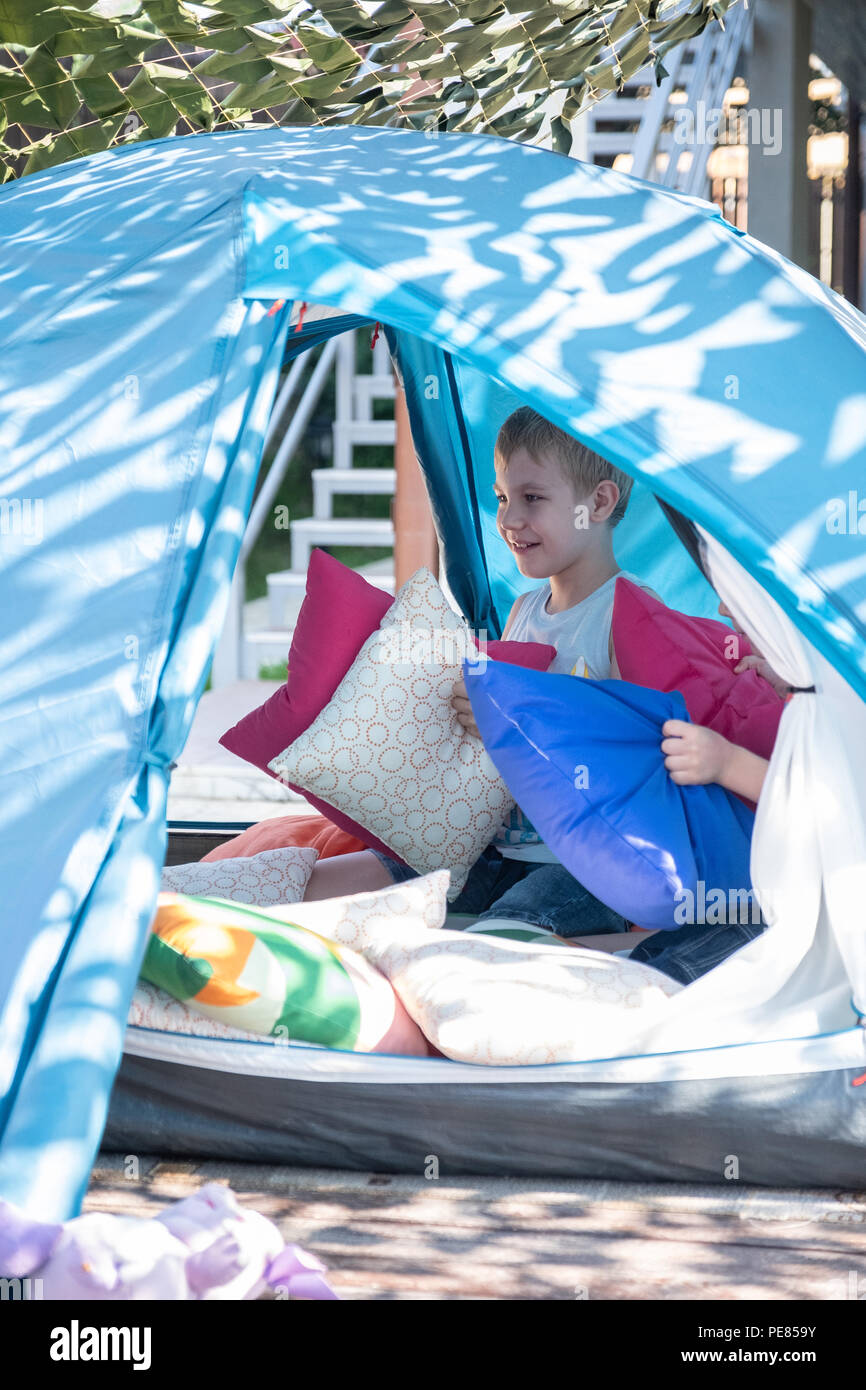 Portrait of cute boy inside tent at backyard Stock Photo - Alamy