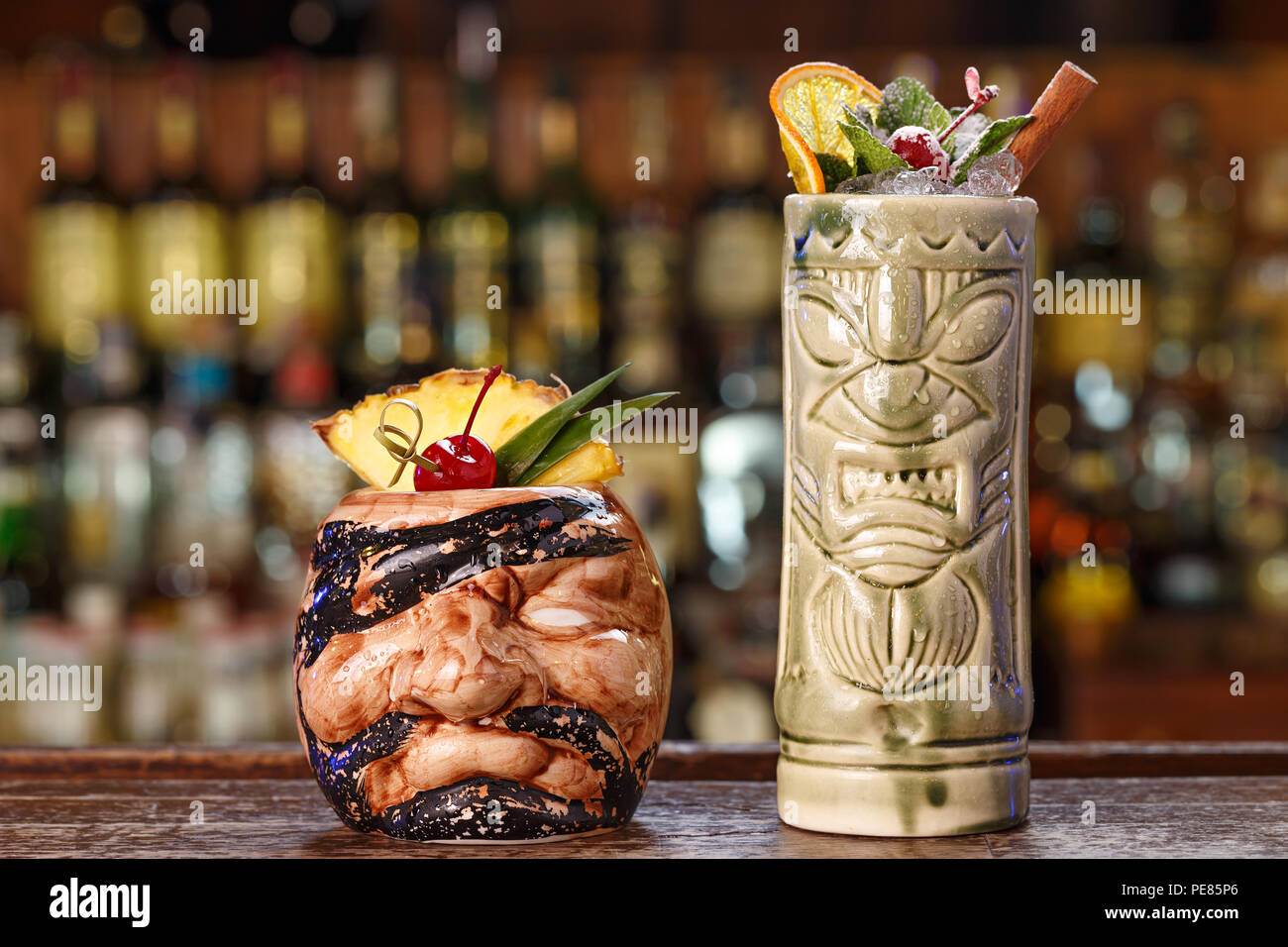 Selected summer alcoholic cocktails on the bar. Cocktails in tiki ...