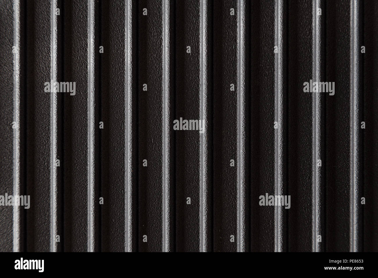 ribbed cast iron surface, metal texture, textured black background ...