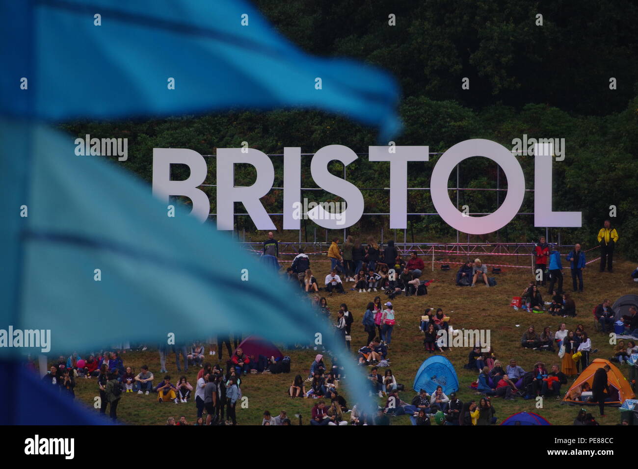 Bristol Name Sign on a Grassy Spectator Hill, Between Blue Banner Flags ...