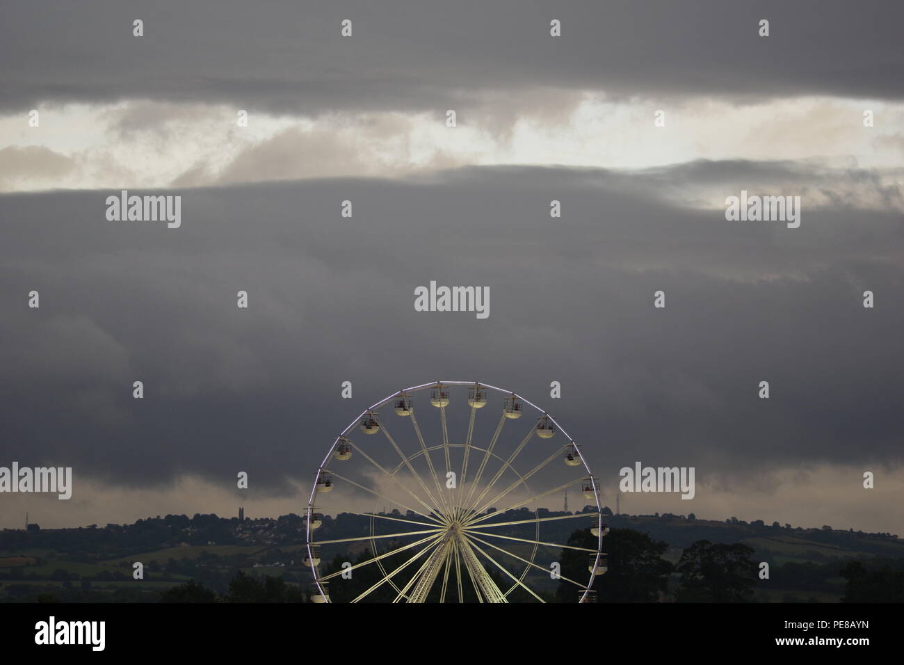 Ferris wheel against a grey stratus cloudy sky. Bristol International ...