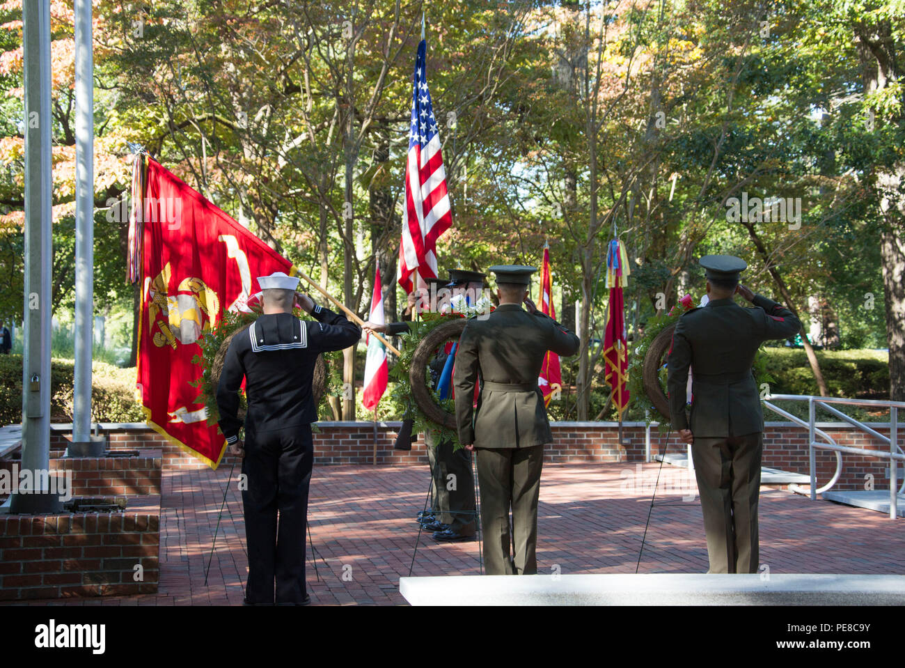 Service members salute as the National anthem is played during the 32nd ...