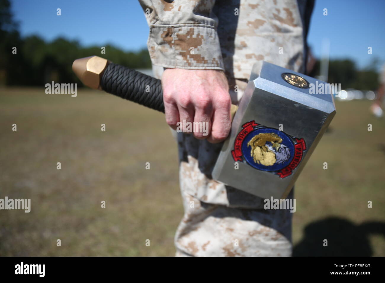 A Marine holds onto the trophy before it is presented to the winner of ...