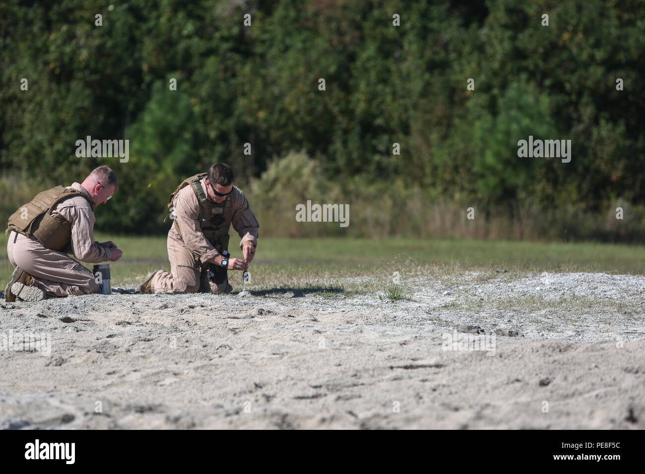 Marines with Explosive Ordnance Disposal Company set-up a shape charge ...
