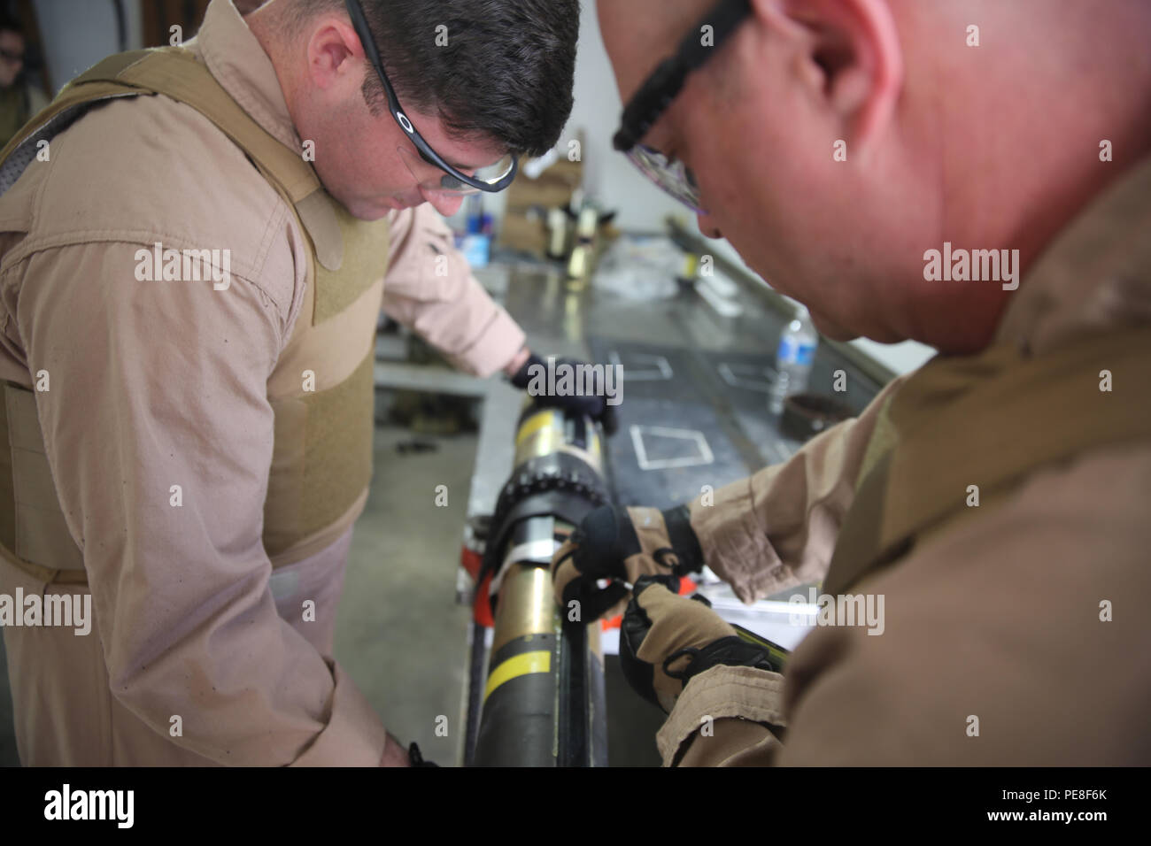 Marines with Explosive Ordnance Disposal Company attempt to disassemble ...
