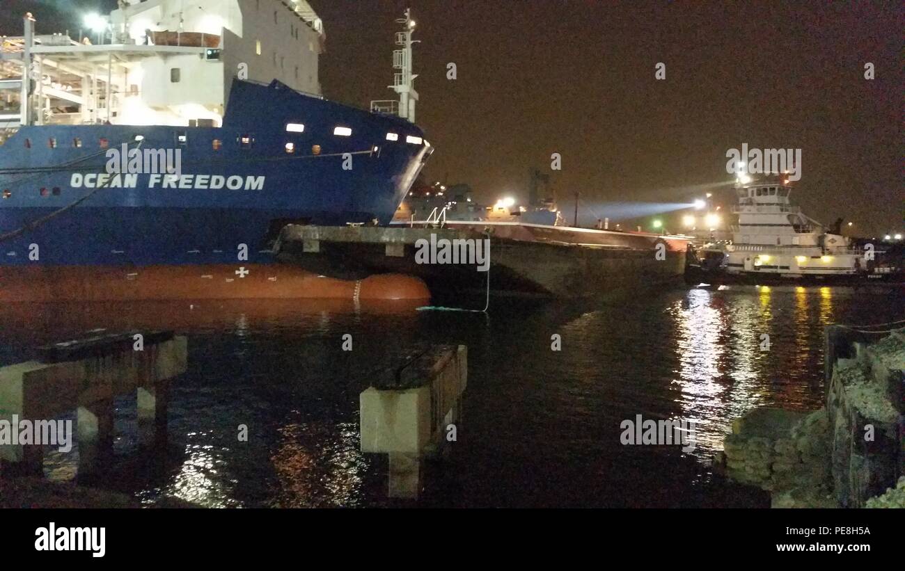 The Ocean Freedom, a 480-foot cargo ship, is connected to a moored ...