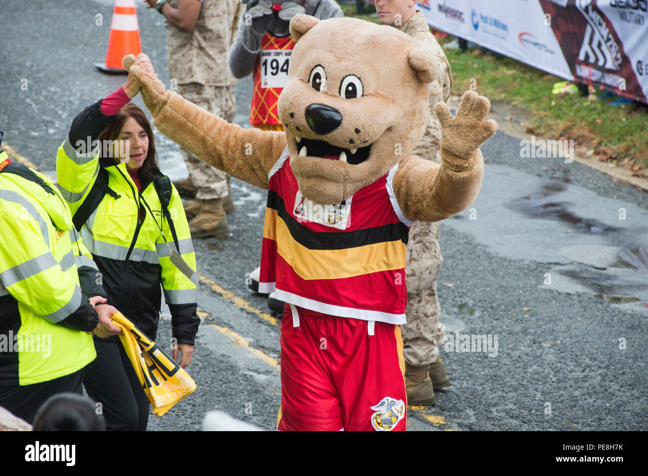 Miles, one of the Marine Corps Marathon (MCM) Mascots, celebrates with ...