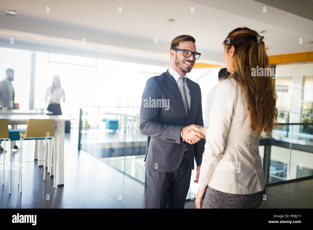Picture of business colleagues talking in office Stock Photo - Alamy