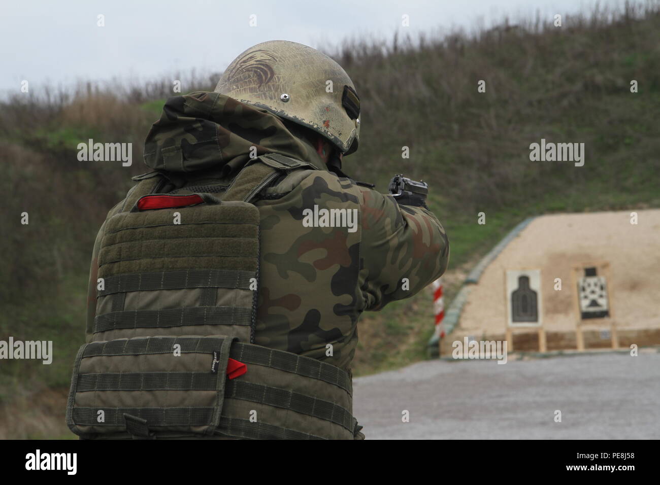 A Polish soldier assigned to Multinational Battle Group-East fires an ...