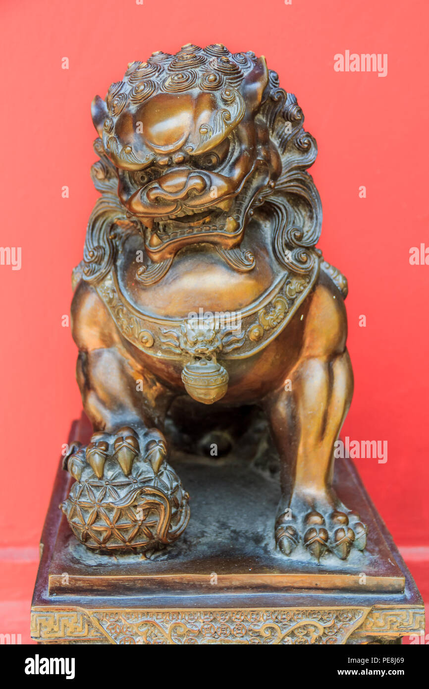 Bronze Chinese lion sculpture, male of the pair, holding a ball ...
