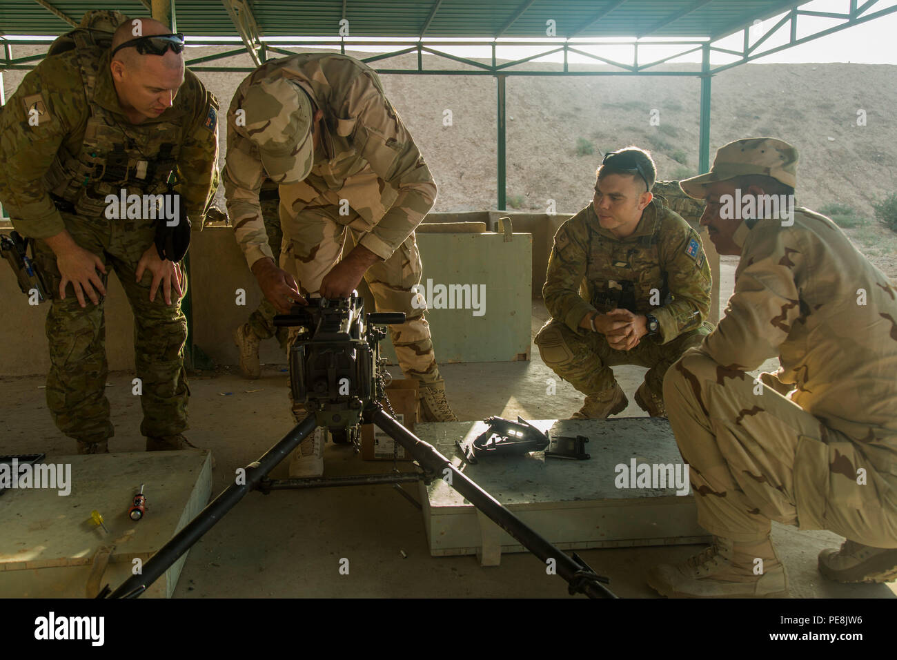 Iraqi soldiers assigned to the 71st Iraqi Army Brigade disassembles a ...