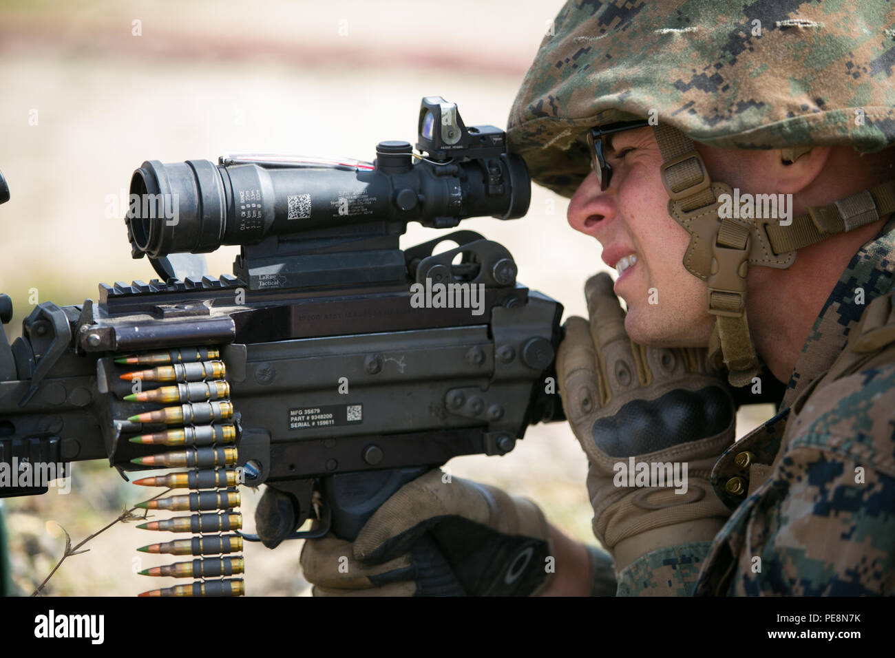 Cpl. Craig Bessette, a radio operator with the 11th Marine Expeditionary Unit (11th MEU), sights ...