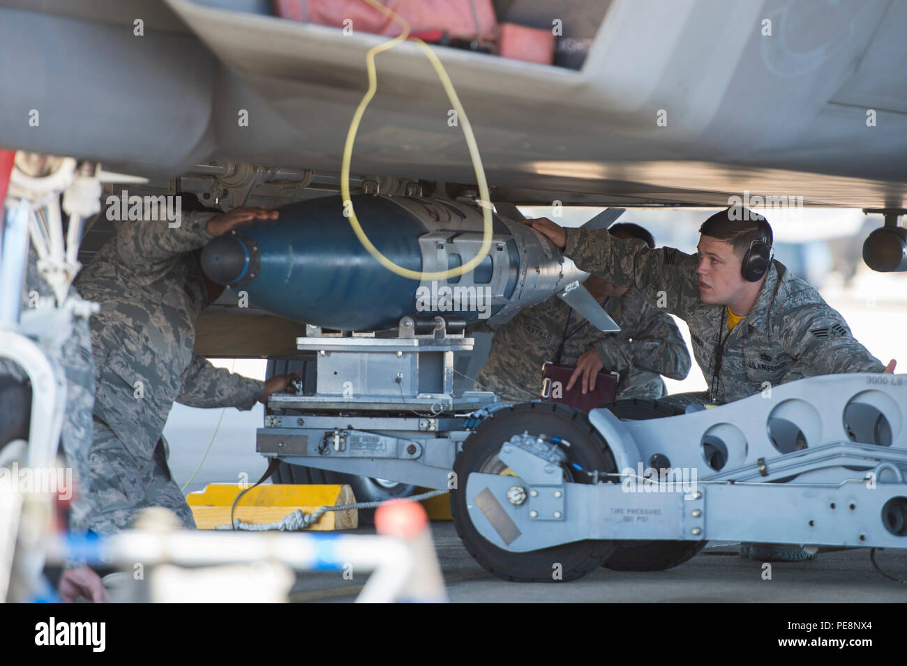 U.S. Air Force Airmen assigned to the 27th Fighter Squadron load a GBU ...