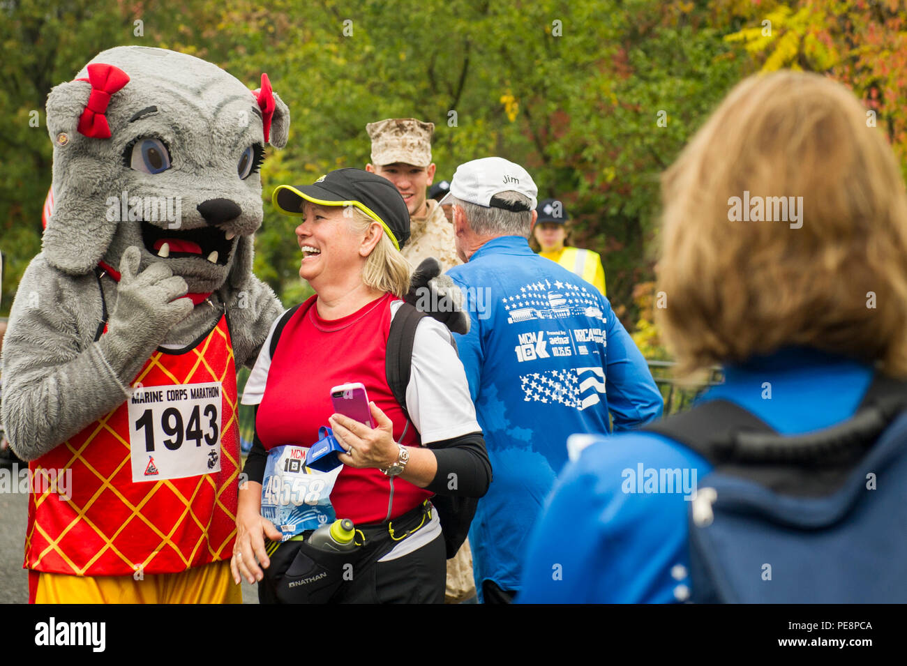 Sandy Morgan, from Utah, poses for a photo with Molly, a Mascot of the ...