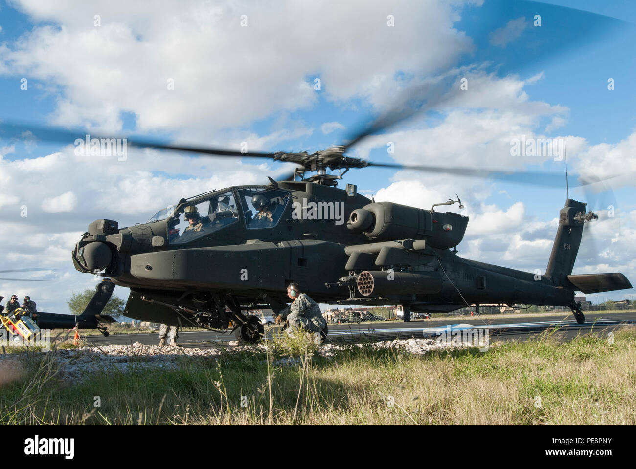 Two AH-64D Apache Longbow helicopters staged at an arming point at ...