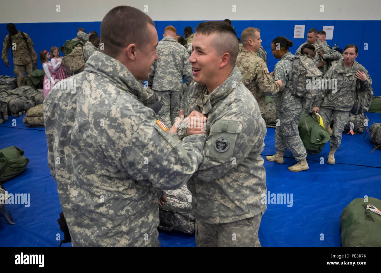 Spc. Joshua Heath, left, greets his friend Spc. Graydon Zanyk, assigned ...