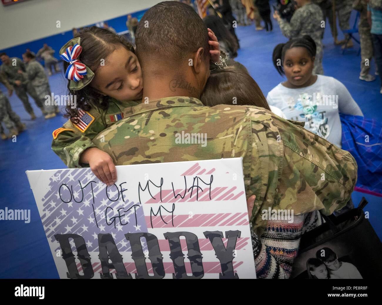 Emilee King, 3, kisses her father Army Staff Sgt. Demarcus King ...