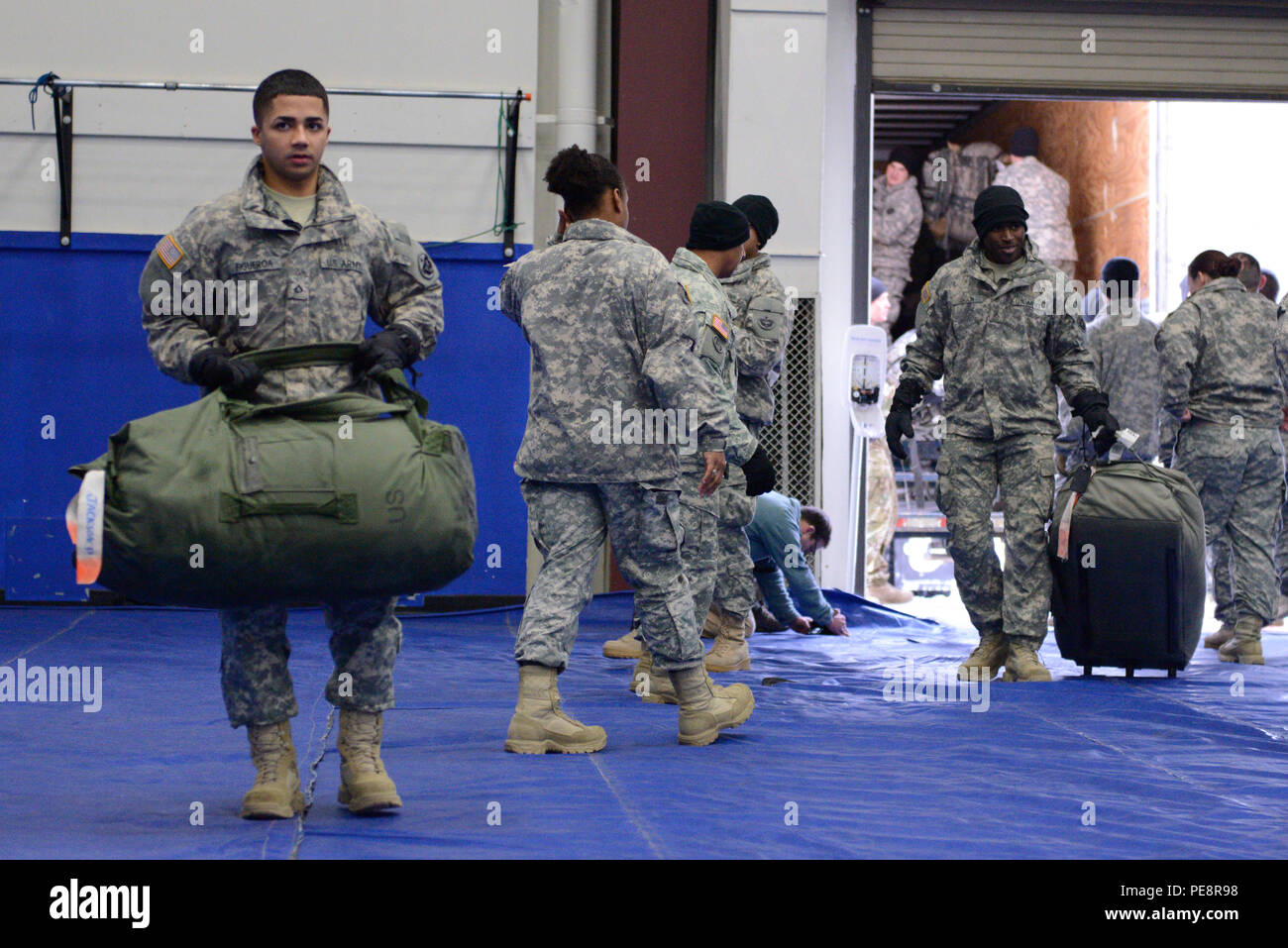 Soldiers unload the bags of service members assigned to the 98th ...