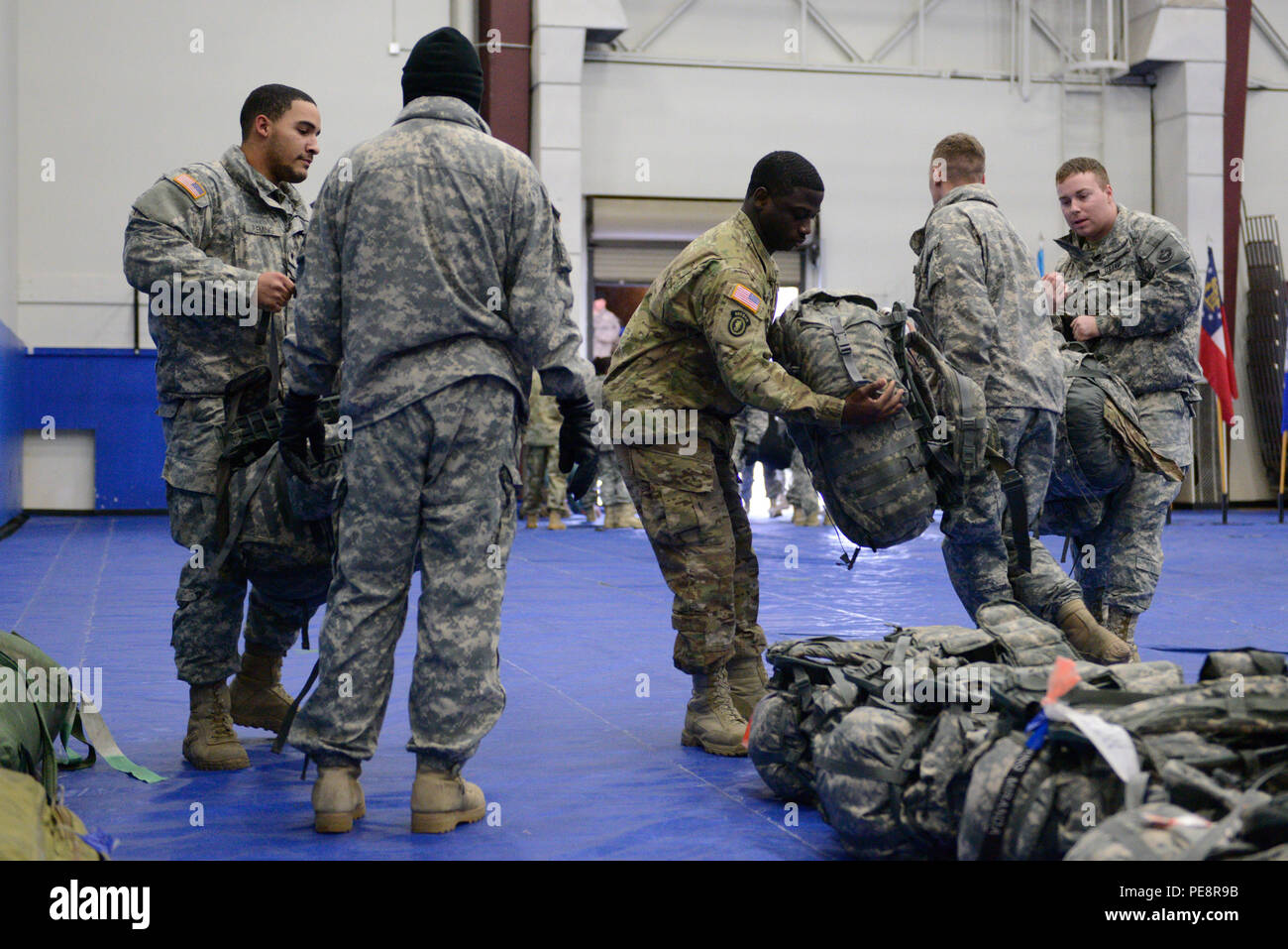 Soldiers unload the bags of service members assigned to the 98th ...