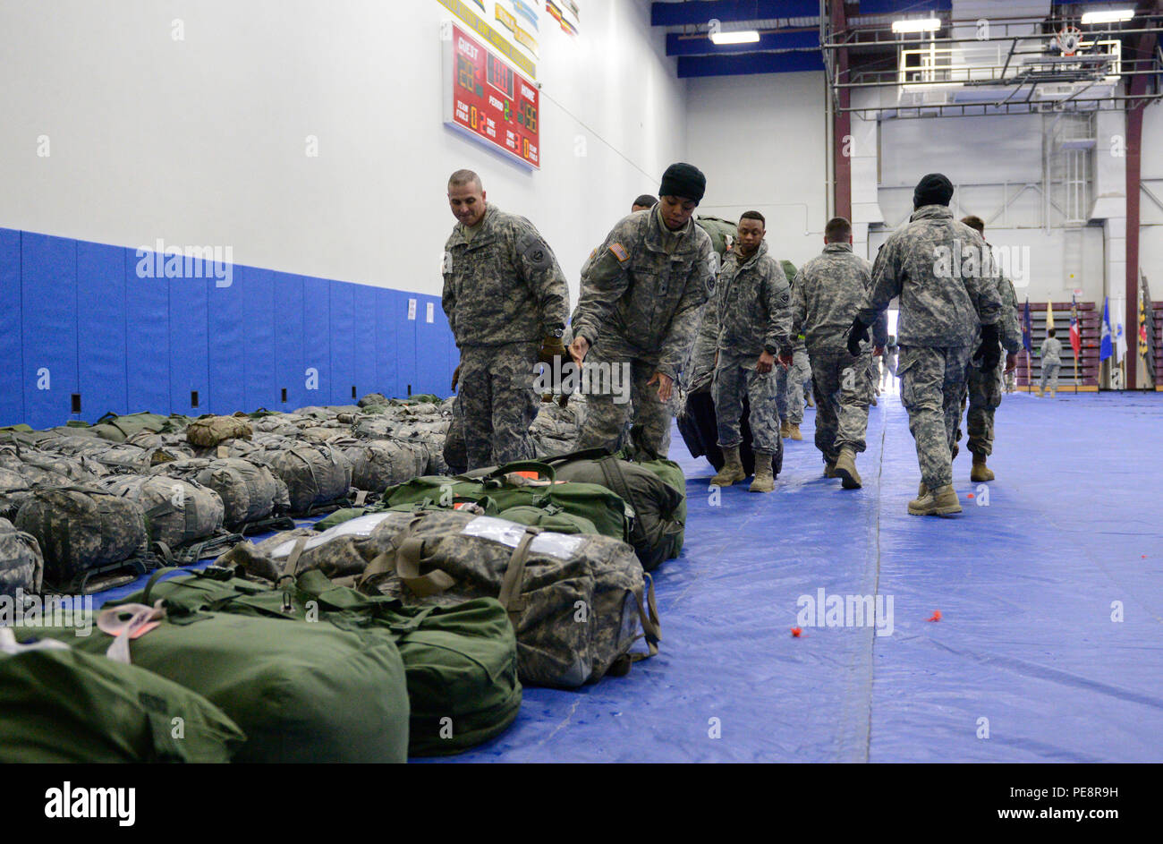 Soldiers unload the bags of service members assigned to the 98th ...