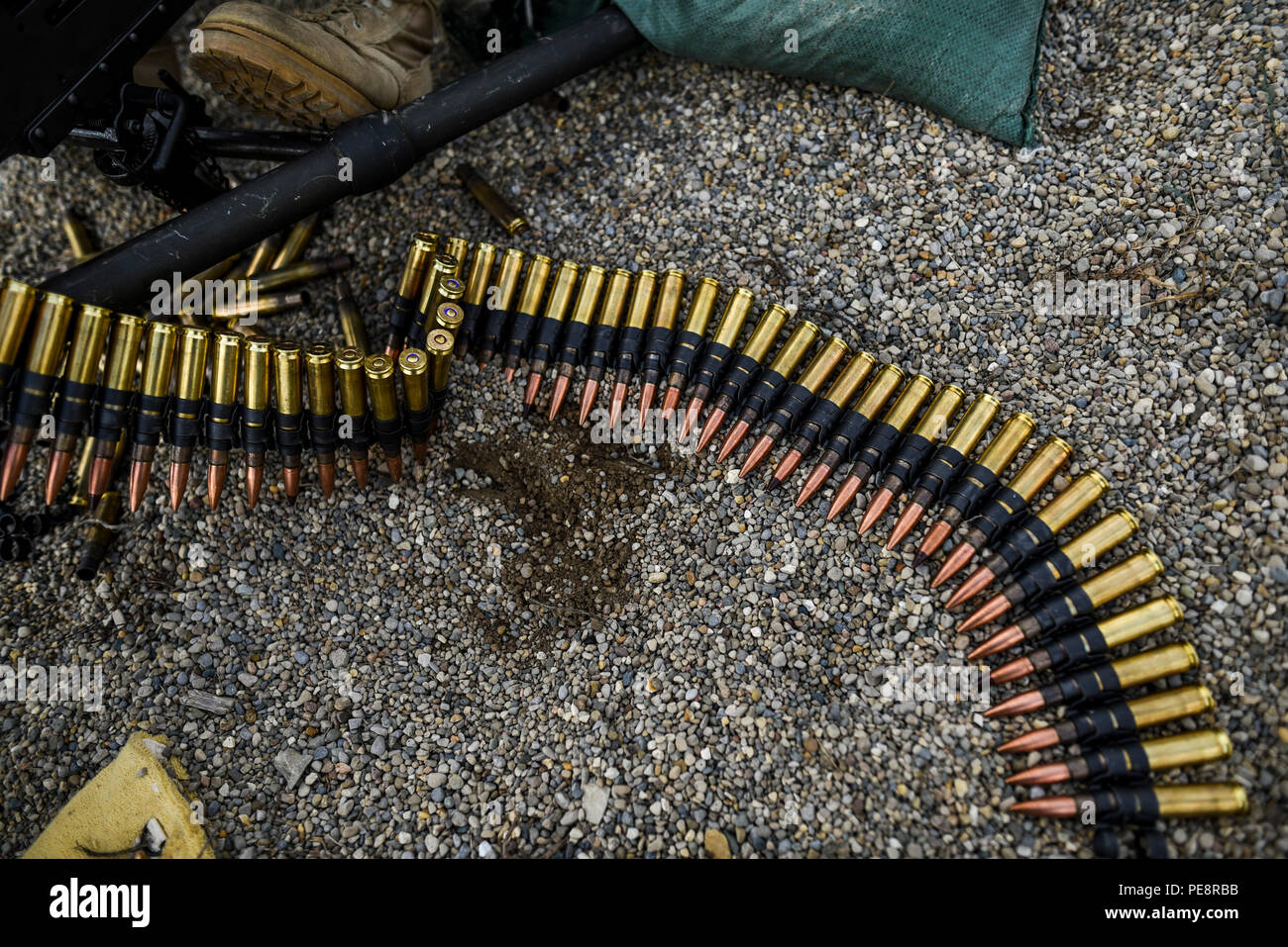 A clip of .50-caliber rounds is loaded into an M2 Browning machine gun ...