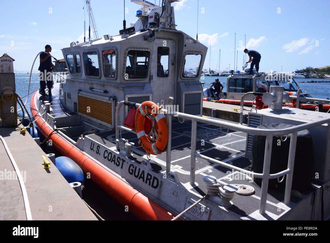 Crew members wash down a 45-foot Response Boat-Medium and 29-foot ...