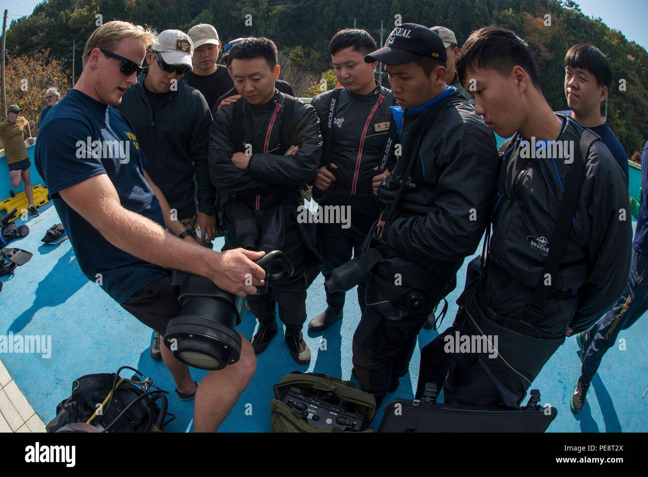 Explosive Ordnance Disposal (EOD) technician 3rd Class Aaron Ainley, left, assigned to EOD ...