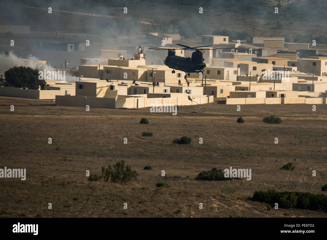 NATO troops fast rope from a U.S. CH-47 Chinook helicopter into the ...