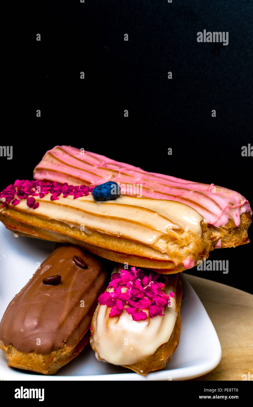 French traditional eclair, decorated with raspberry and cream Stock ...