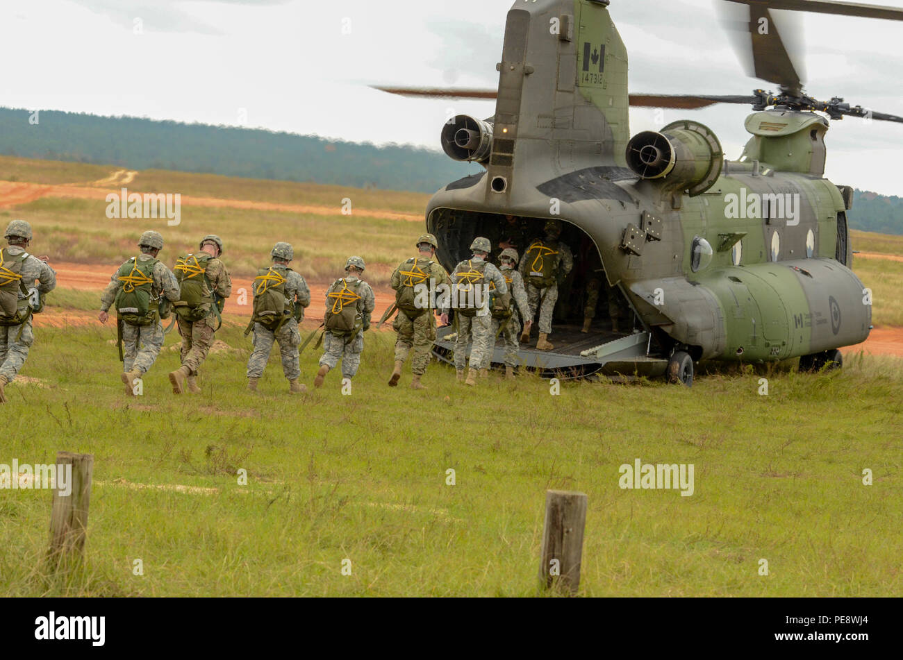U.S. paratroopers with the 82nd Airborne Division load the Canadian CH ...