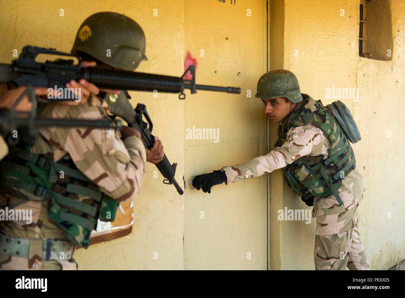 An Iraqi soldier assigned to 71st Iraqi Army Brigade prepares to open a ...