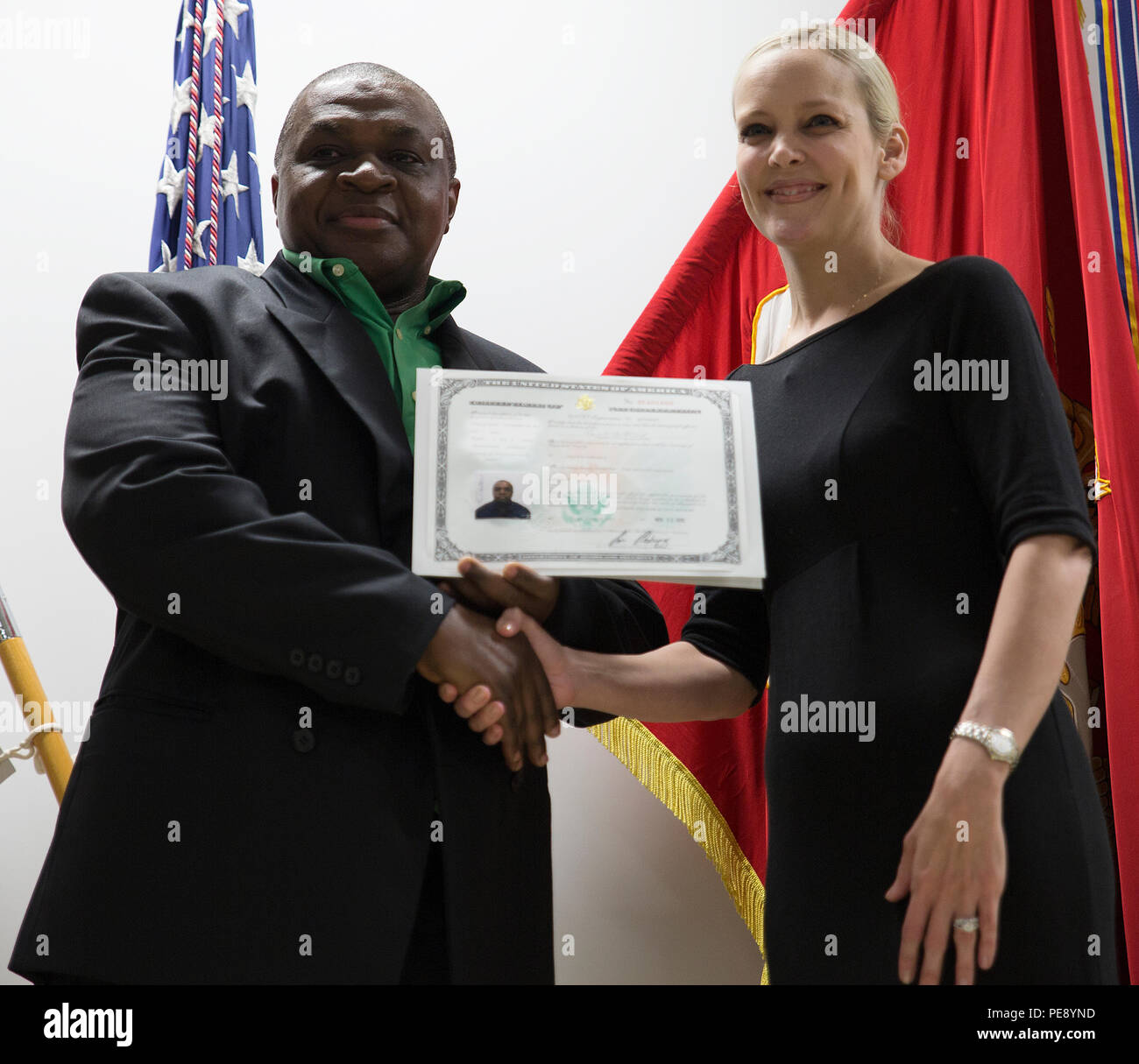 Paul Halstead, left, receives his certificate of naturalization from ...