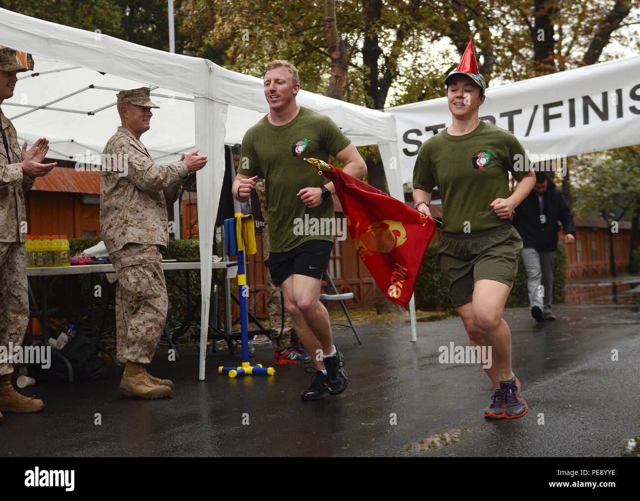 U.S. Marine Maj. Michelle Macandar carries the guidon past the lap ...