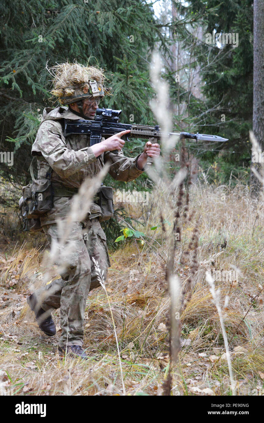 A British Army Royal Military Academy Sandhurst cadet moves toward ...