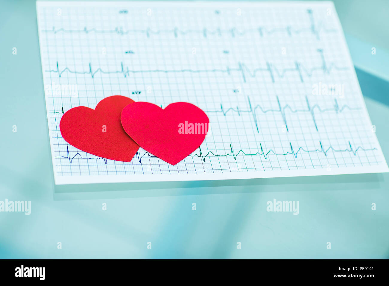 health concept: two red paper heart on the electrocardiogram, the ...