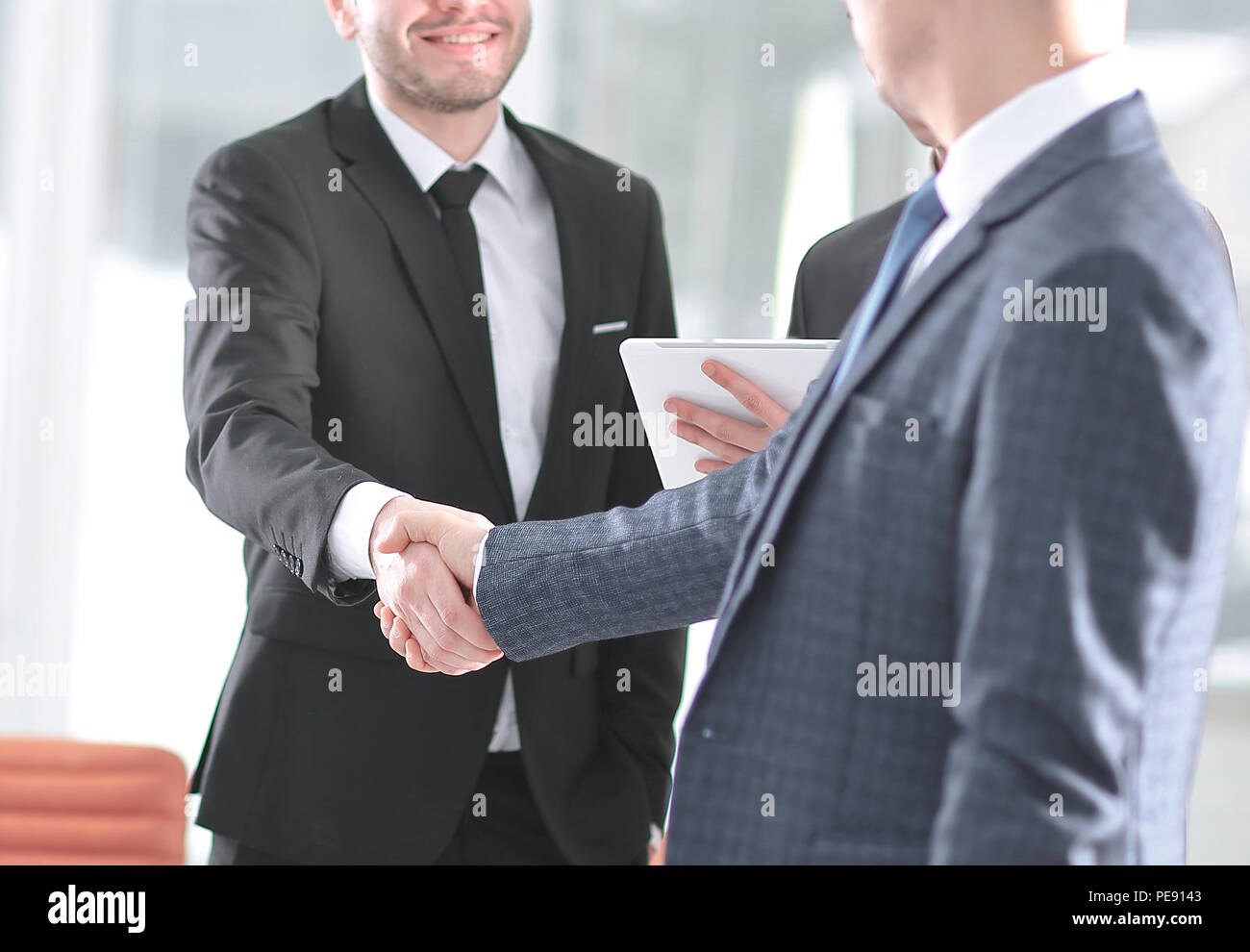 handshake business partners standing next to the Bank office Stock Photo - Alamy