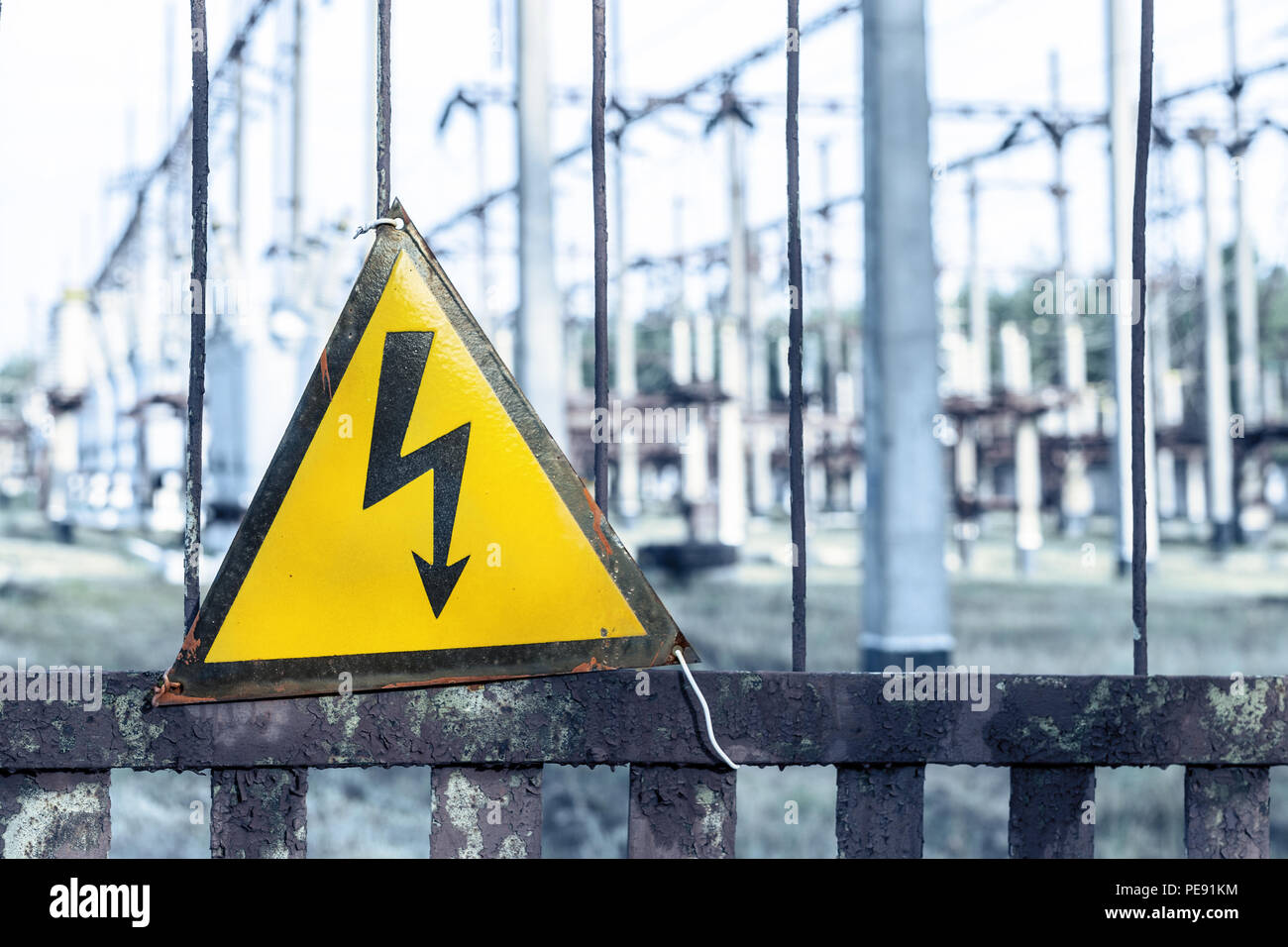 Close-up old aged rusty triangle metal plate with High voltage warning ...
