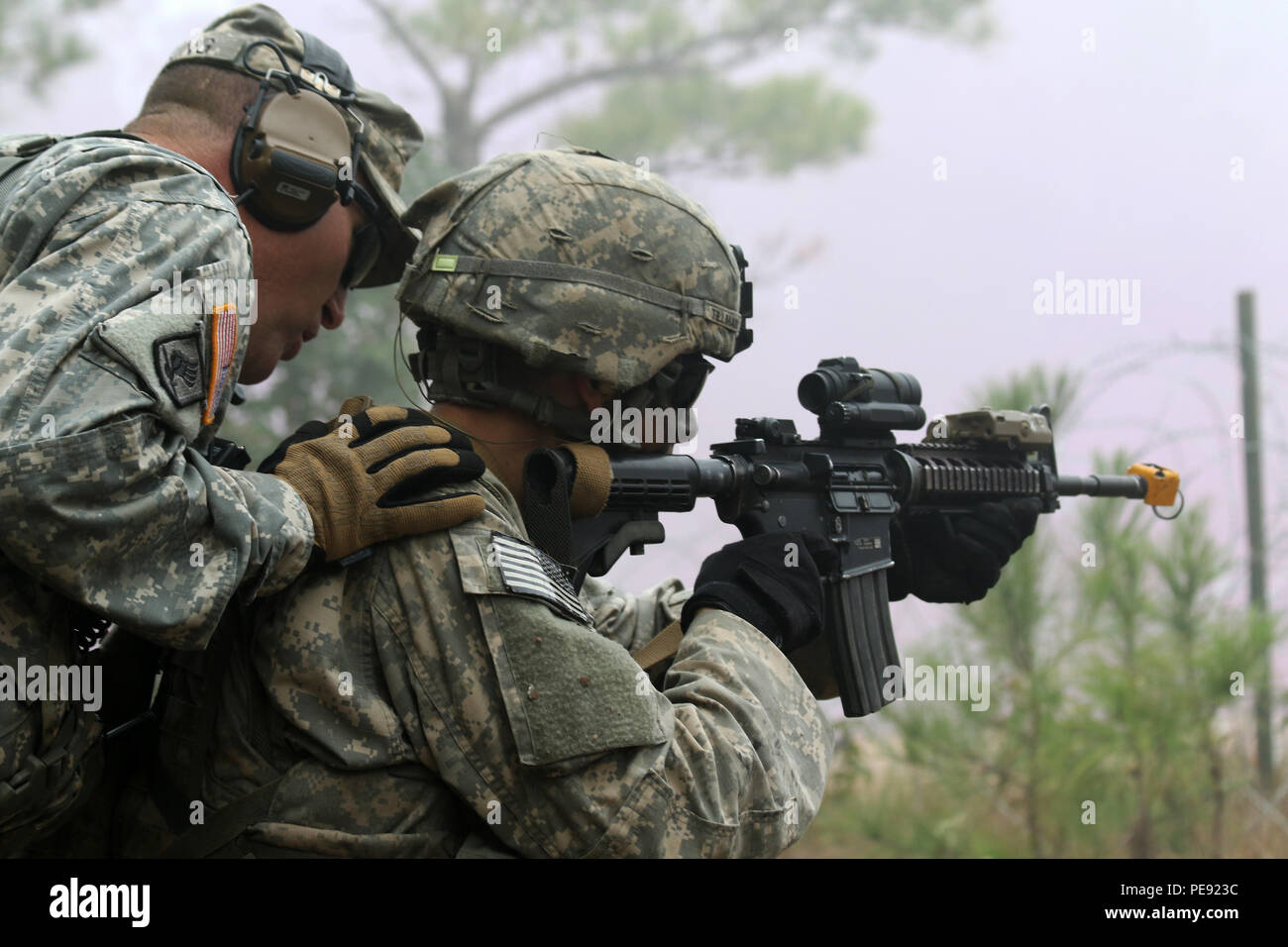 An Observer, Controller, Trainer (OCT) mentors a young infantryman ...