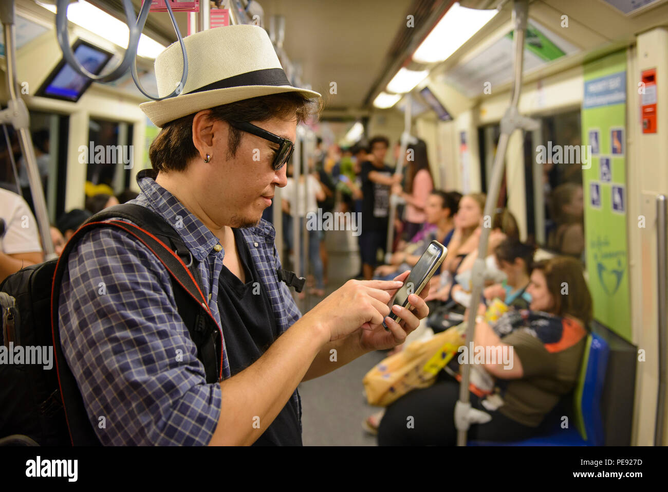 Man looking the mobile in metro hi-res stock photography and images - Alamy
