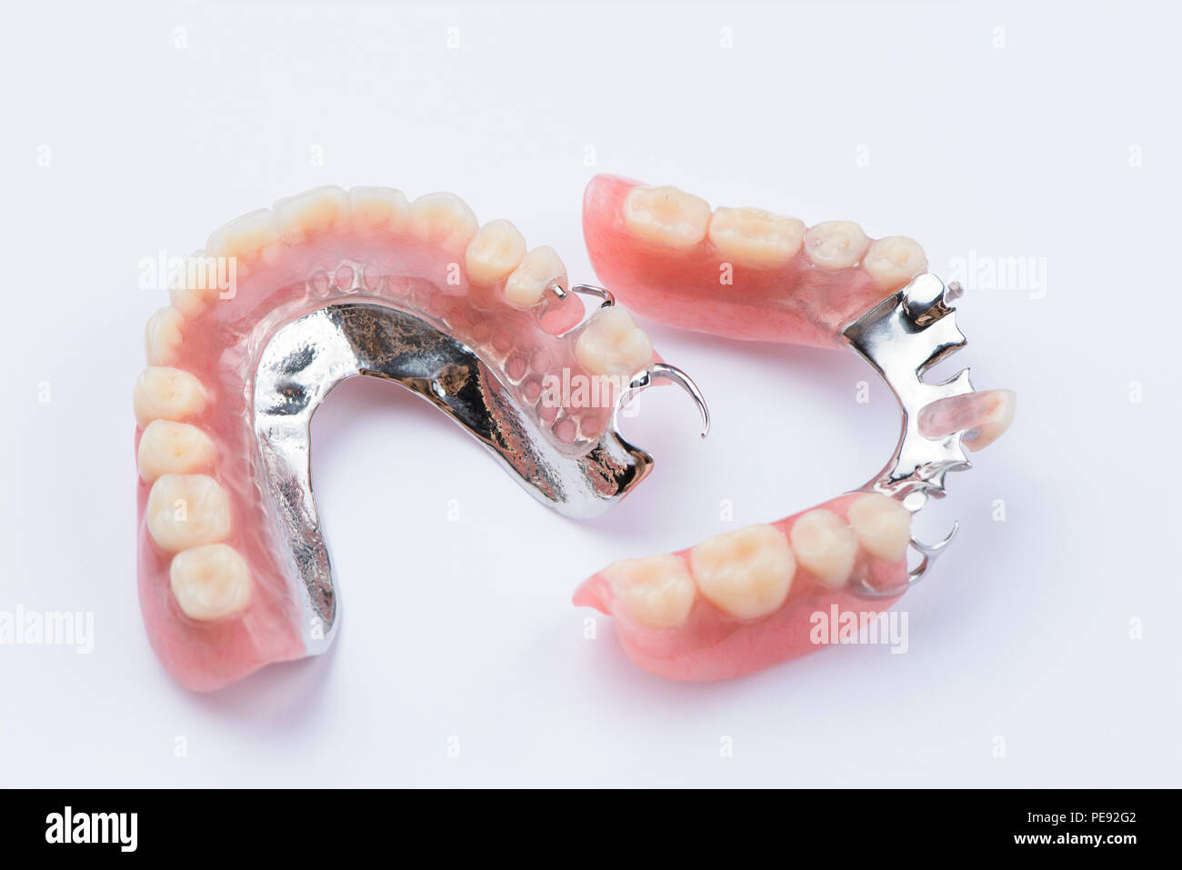 Removable metal partial denture on white background Stock Photo - Alamy
