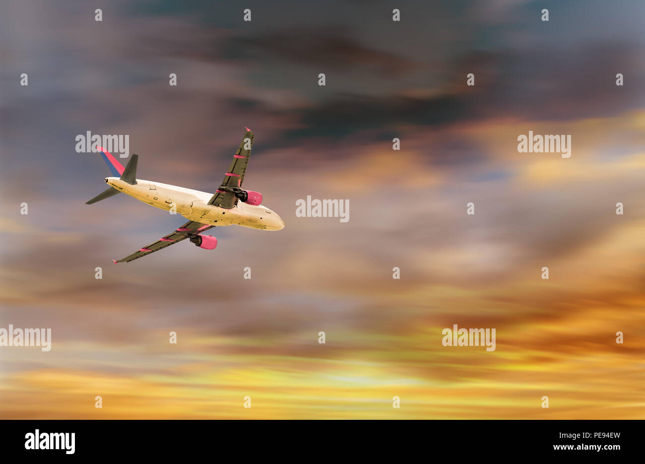 A plane flying towards a beautiful sunset Stock Photo - Alamy