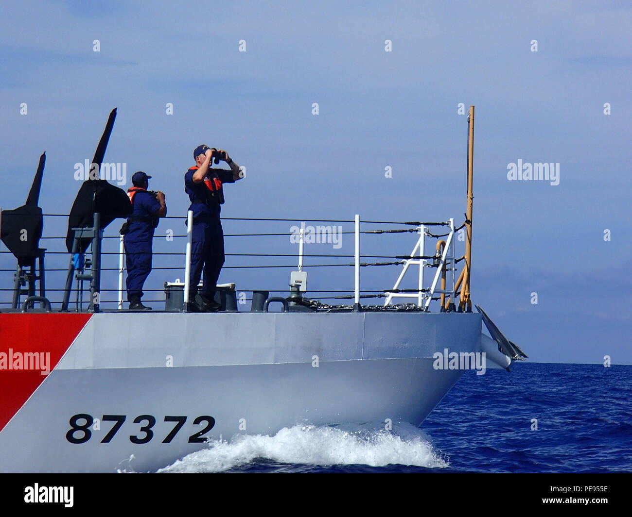 The crew of the Coast Guard Cutter Alligator keep a sharp lookout for a ...