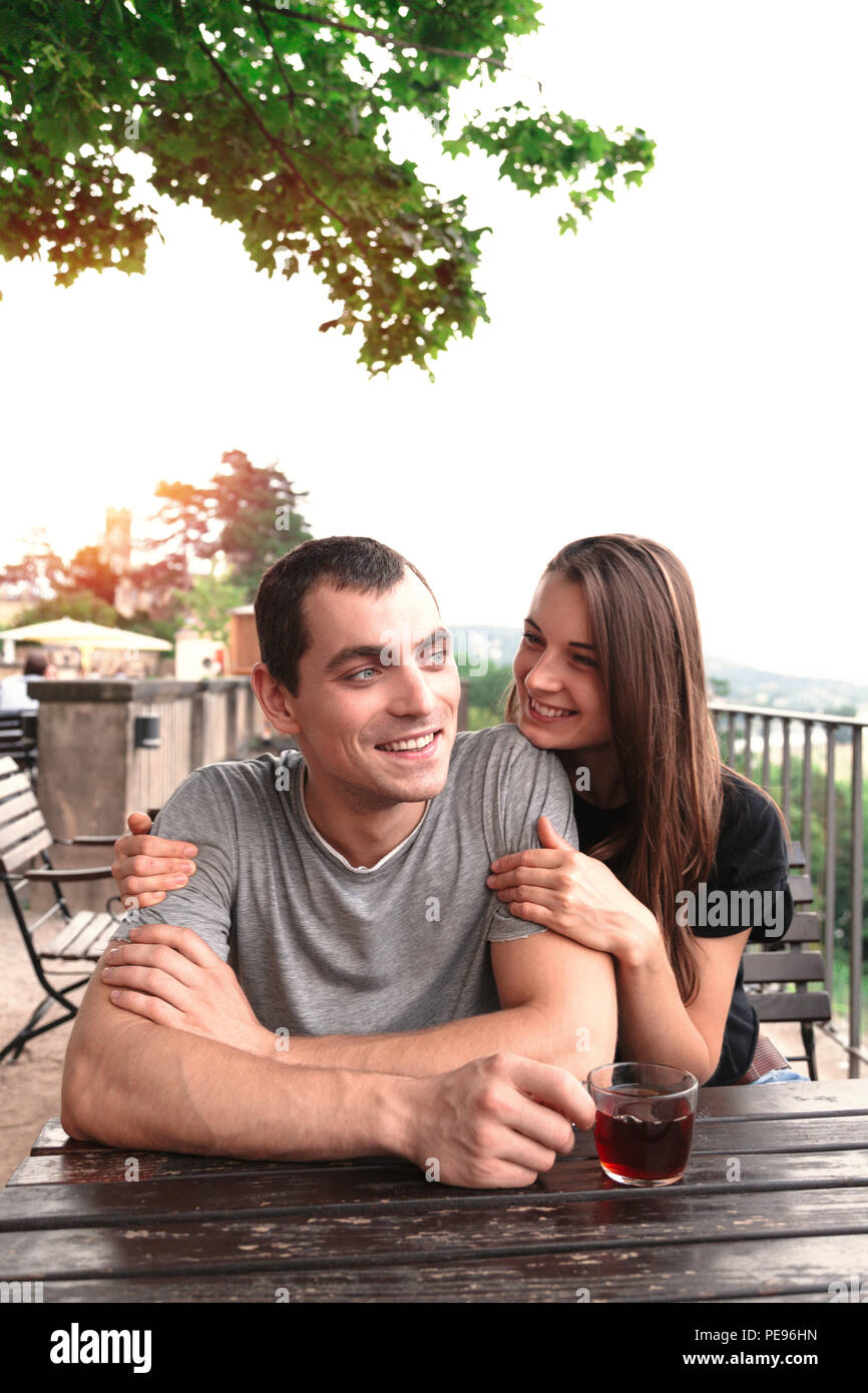 Young beautiful couple share tea at garden table Stock Photo - Alamy