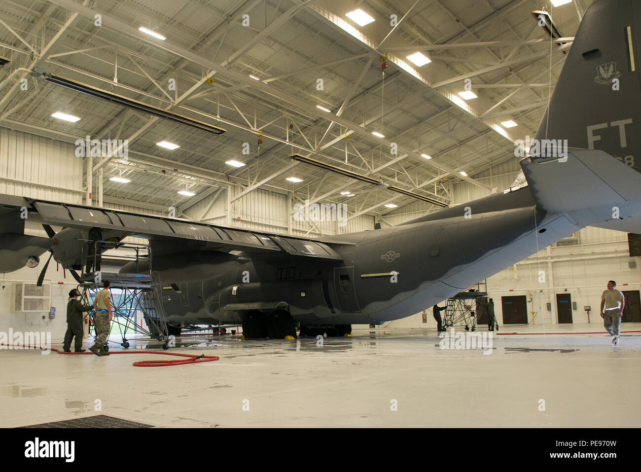 Airmen from the 71st Rescue Squadron clean an HC-130J Sky King in the ...