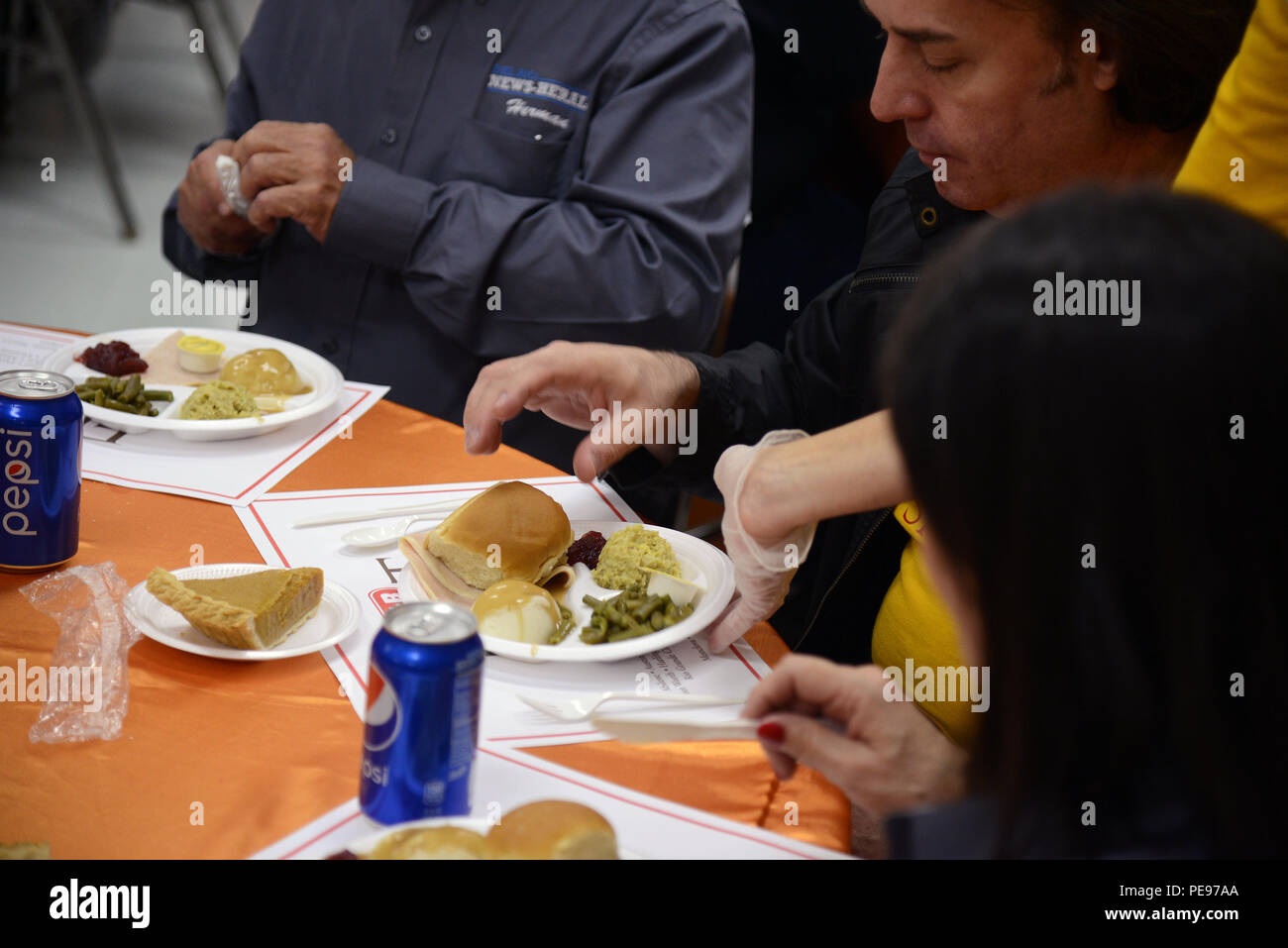 A volunteer serves food at the H-E-B Feast of Sharing at the Del Rio ...