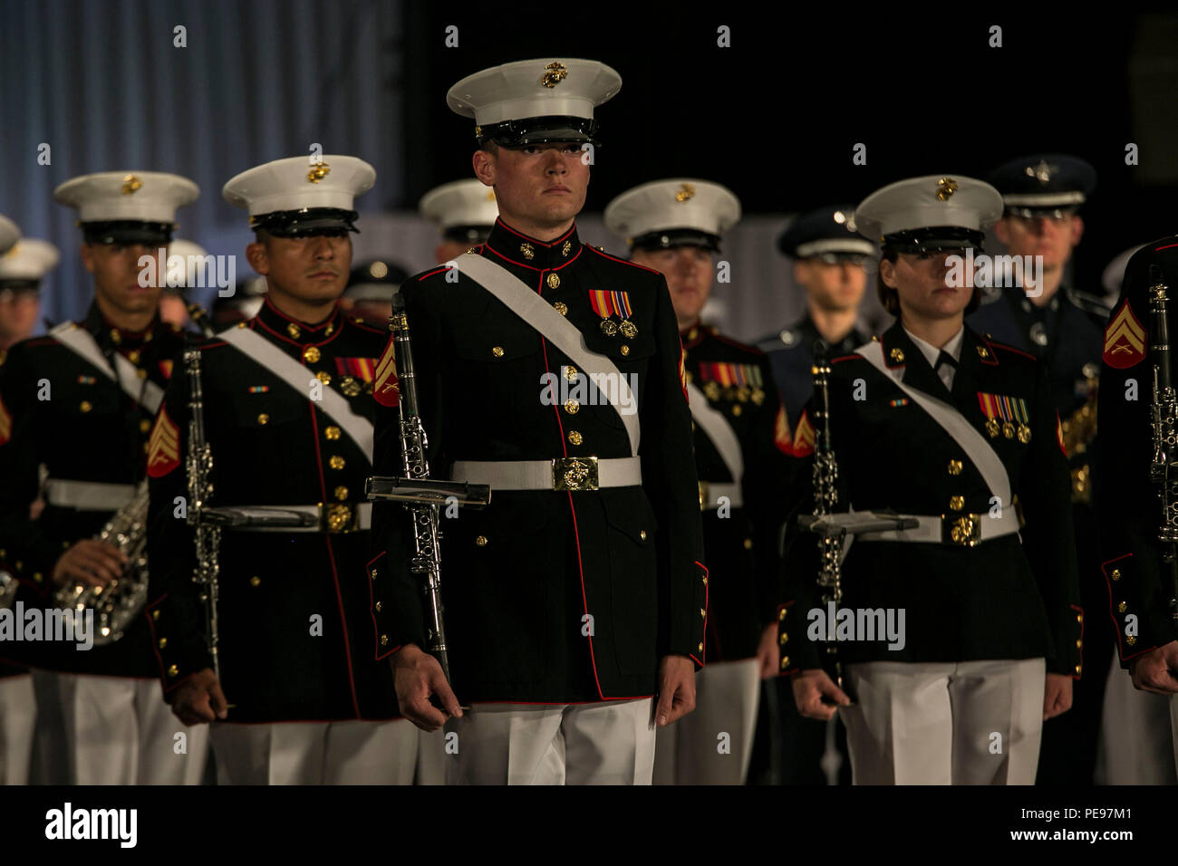 U.S. Marines prepare to perform after marching on stage with members of ...